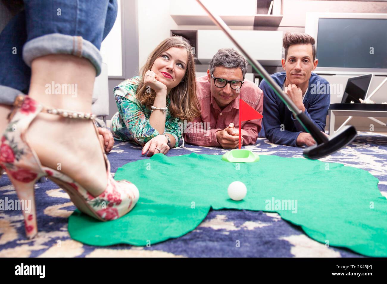 group of young adults have fun playing golf in the living room Stock ...