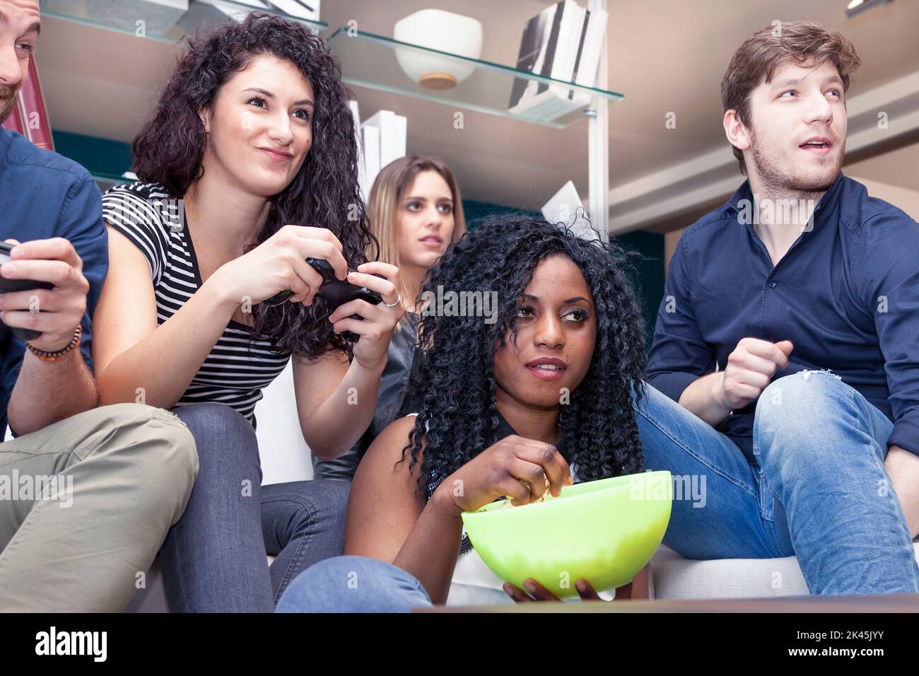 group of people having fun on the couch playing with the joystick Stock ...