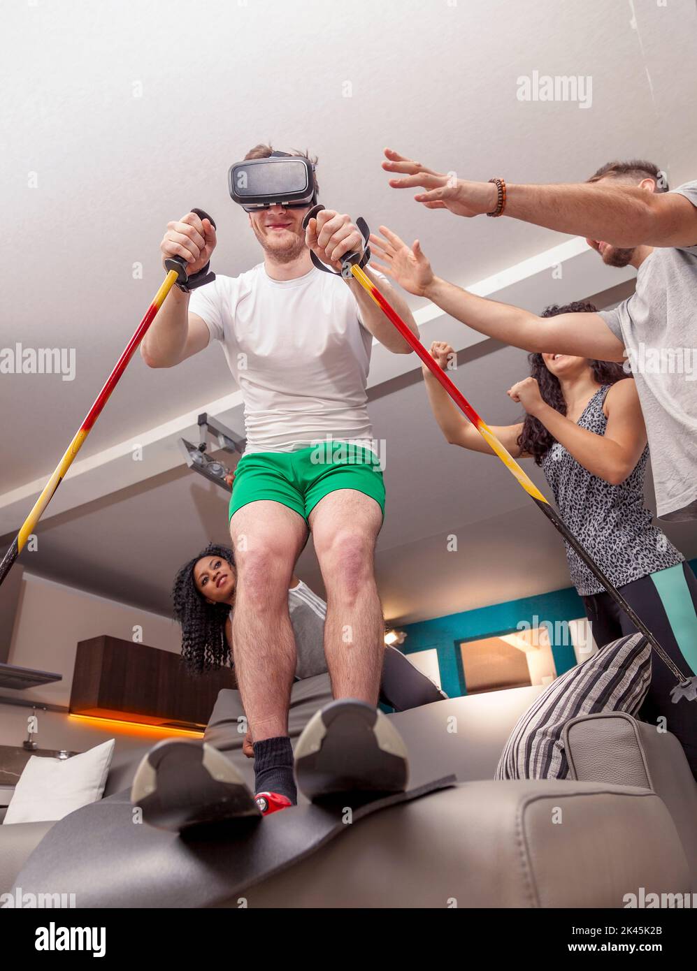 group of friends having fun at home skiing using viewer for virtual reality Stock Photo - Alamy