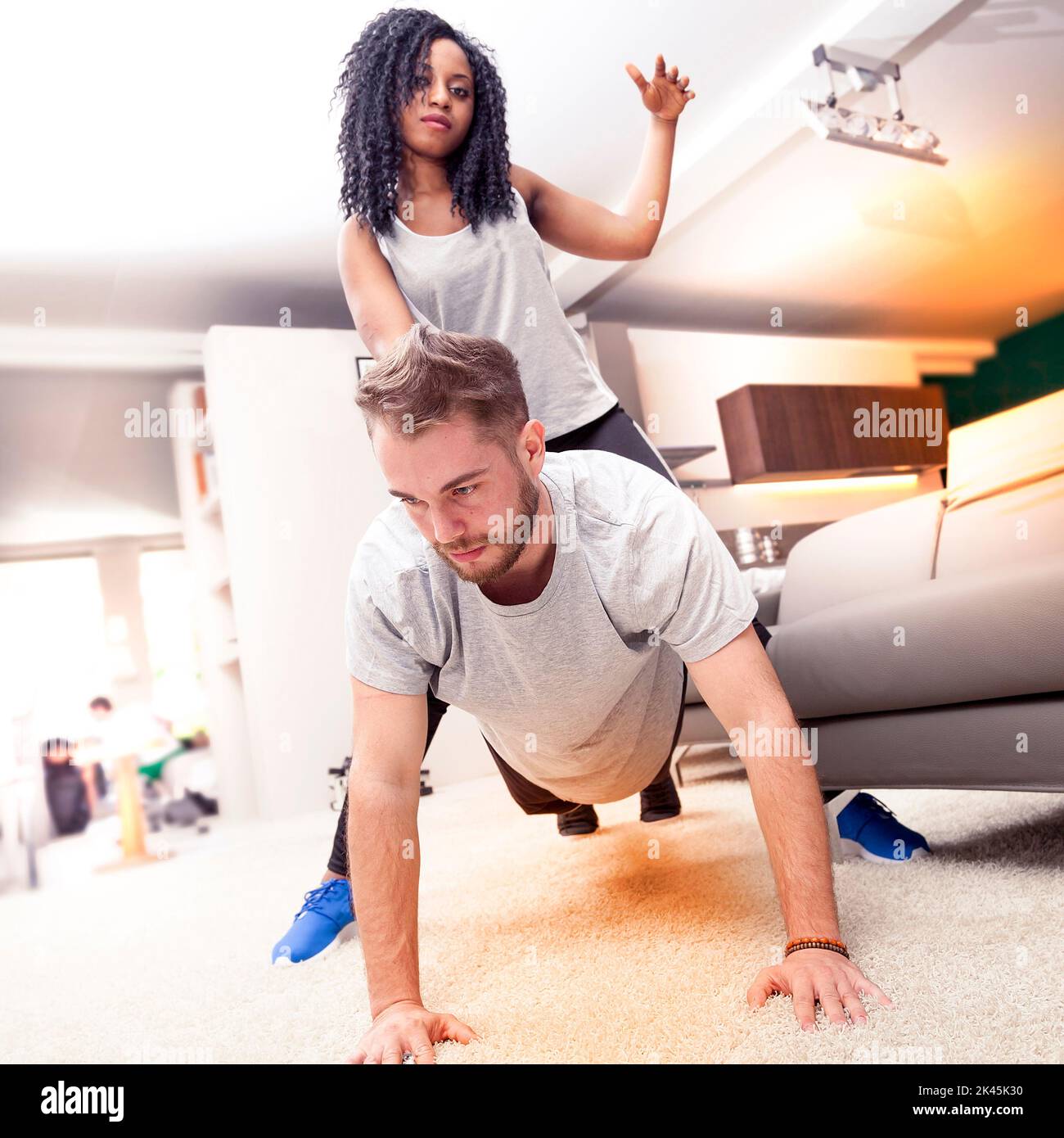 young couple having fun doing gymnastics at home Stock Photo - Alamy