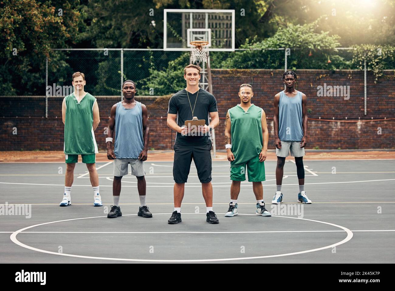 Basketball, sport and team with a coach training his players on a court ...