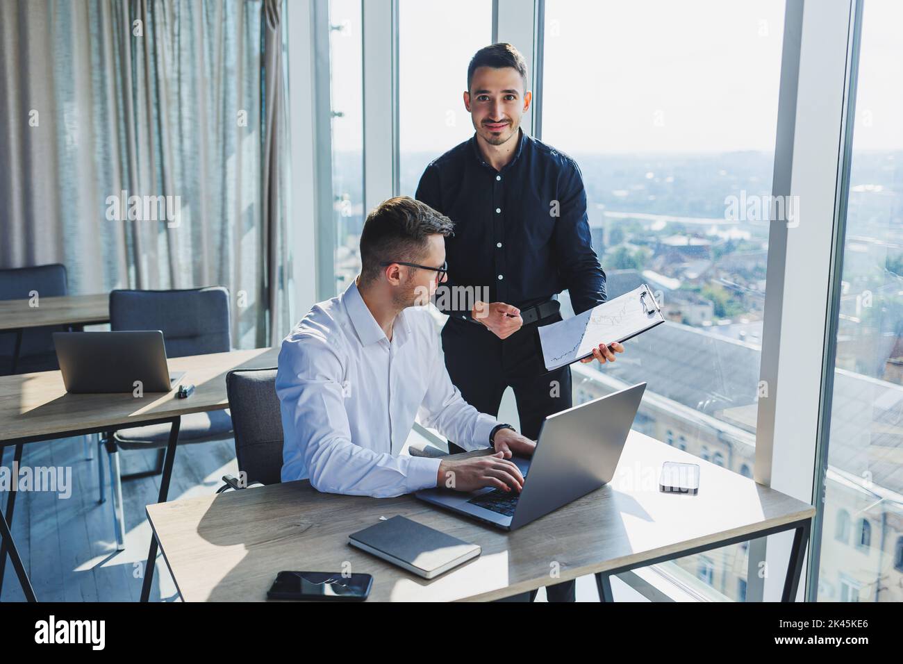 Group of men sharing a computer screen hi-res stock photography and ...