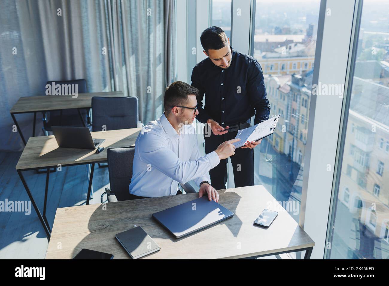 Group of men sharing a computer screen hi-res stock photography and ...
