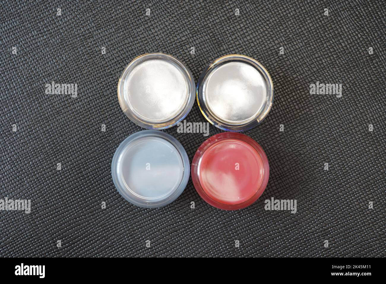 glass Bottle with multi colored plastic caps on black background Stock ...