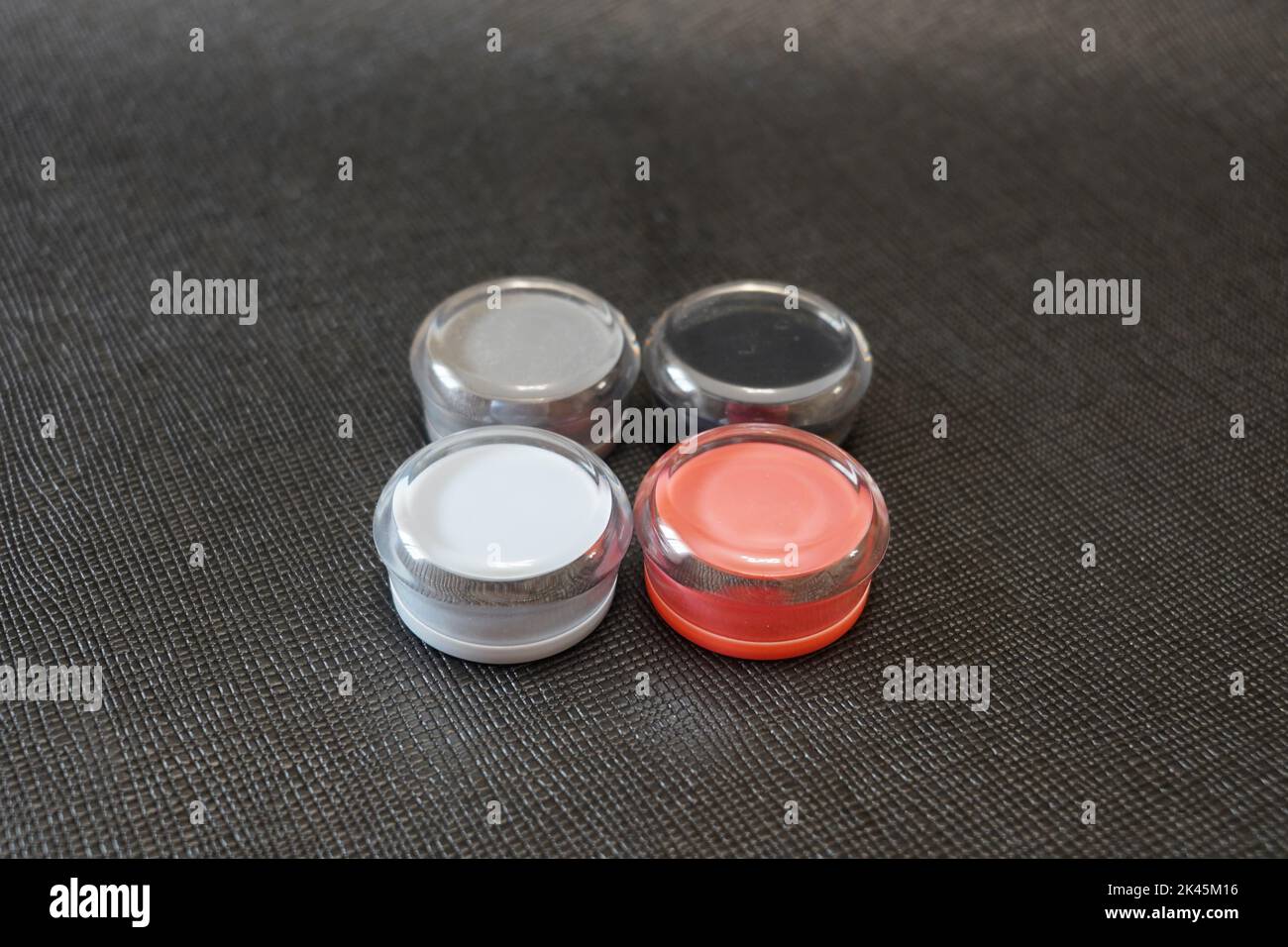 glass Bottle with multi colored plastic caps on black background Stock ...