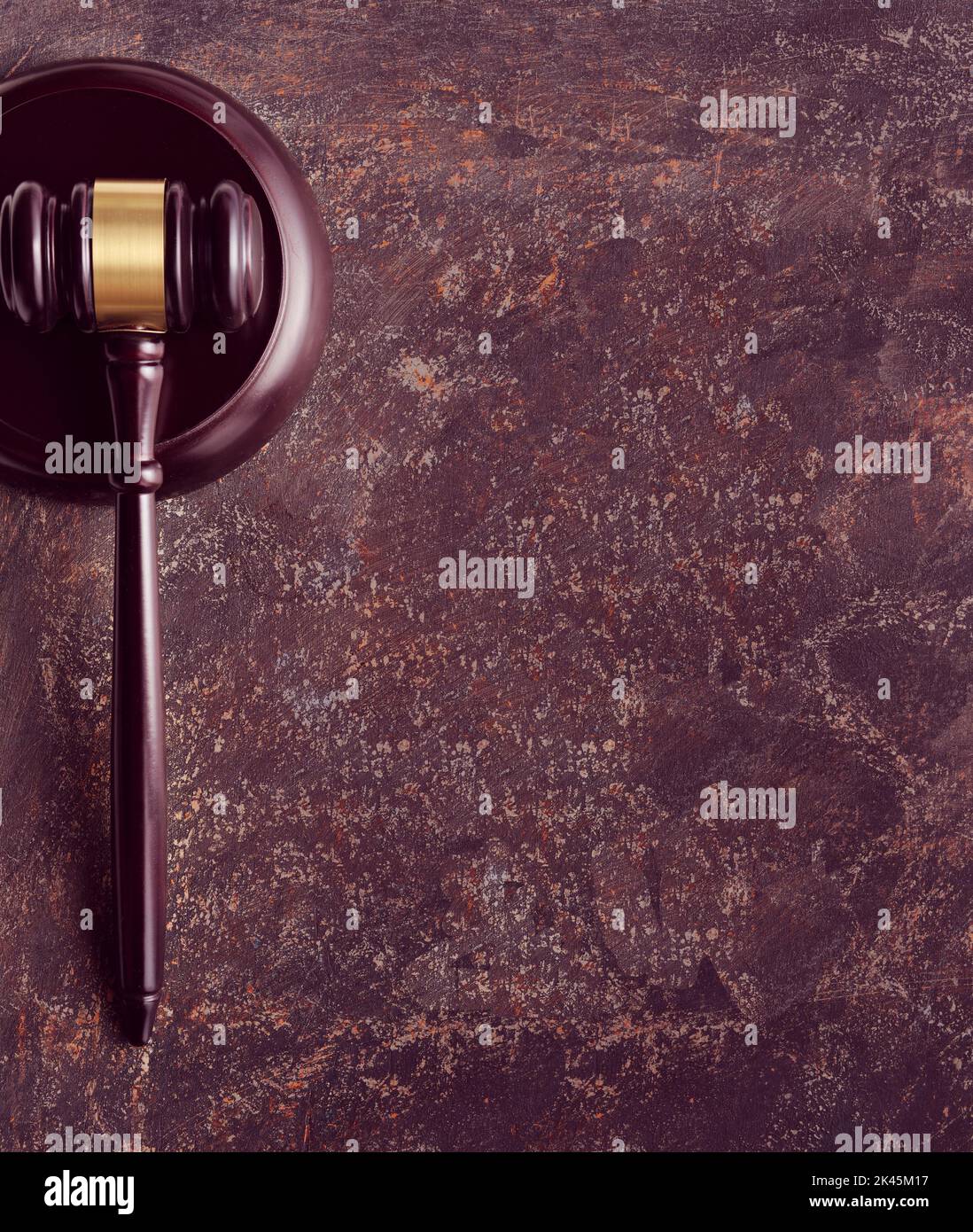Dark polished wooden law hammer or gavel on aged wooden table. Concept ...
