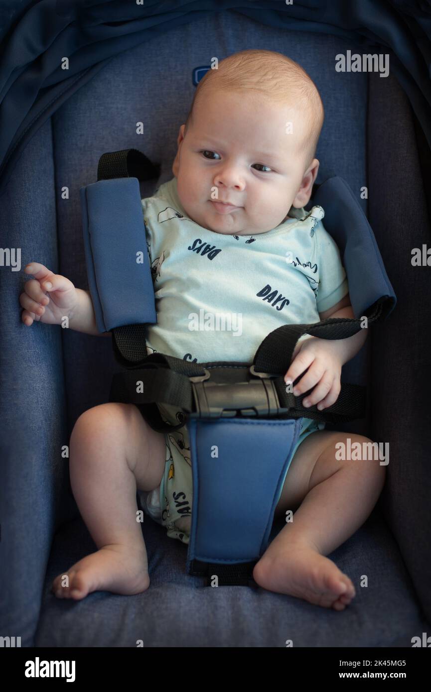 Cute little peaceful baby in his egg shell stroller car seat. Clipping ...