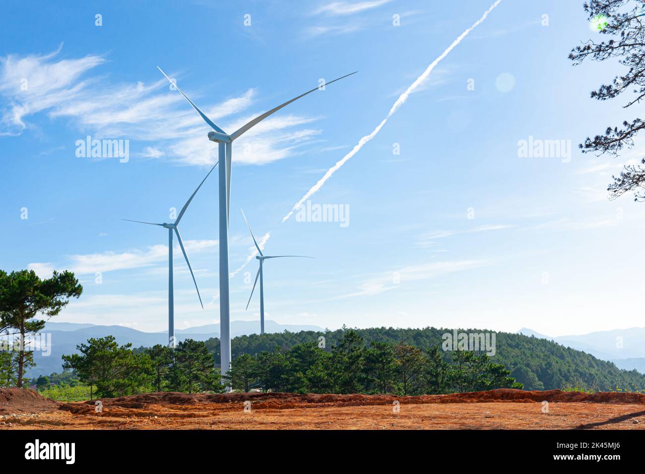 Renewable energy wind turbines windmill isolated on the beautiful blue ...