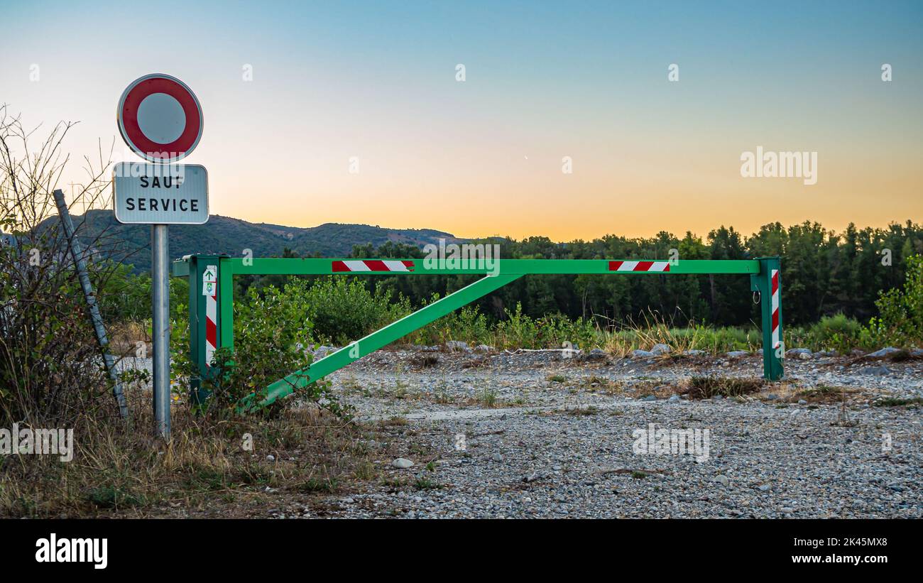 Entrance gate to the factory with a no-entry sign during sunset and ...