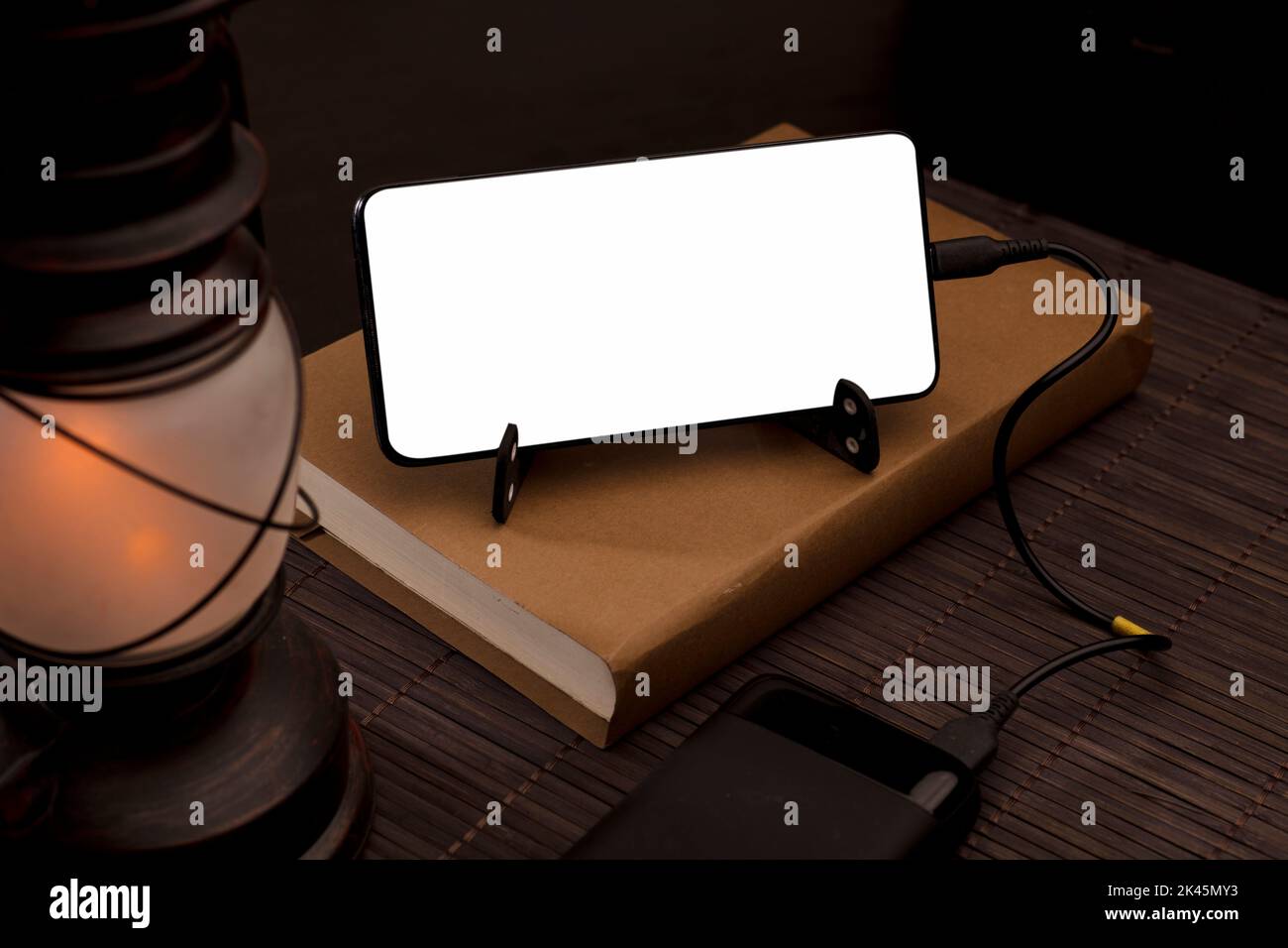 Smartphone with copy space, over wood and oil lamp, social problem ...