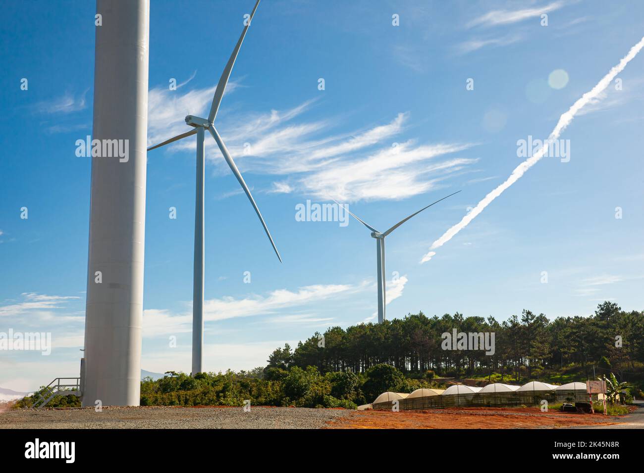 Renewable energy wind turbines windmill isolated on the beautiful blue ...