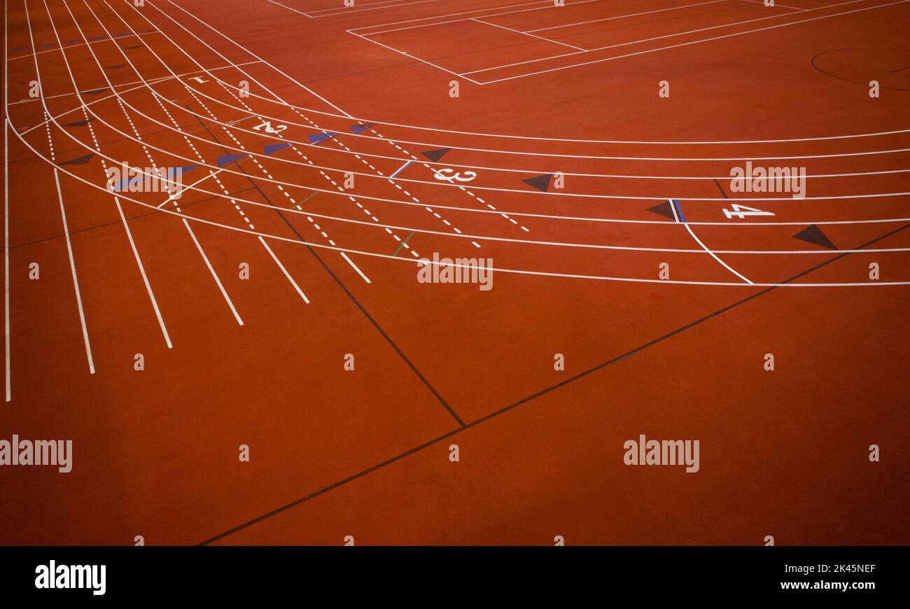 A red running track, athletics ground, a corner section of track marked ...