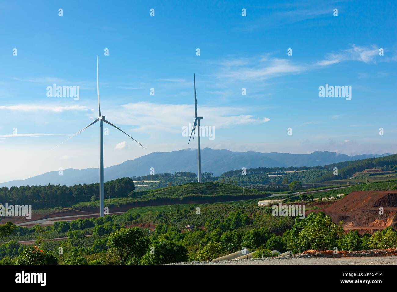 Renewable energy wind turbines windmill isolated on the beautiful blue ...