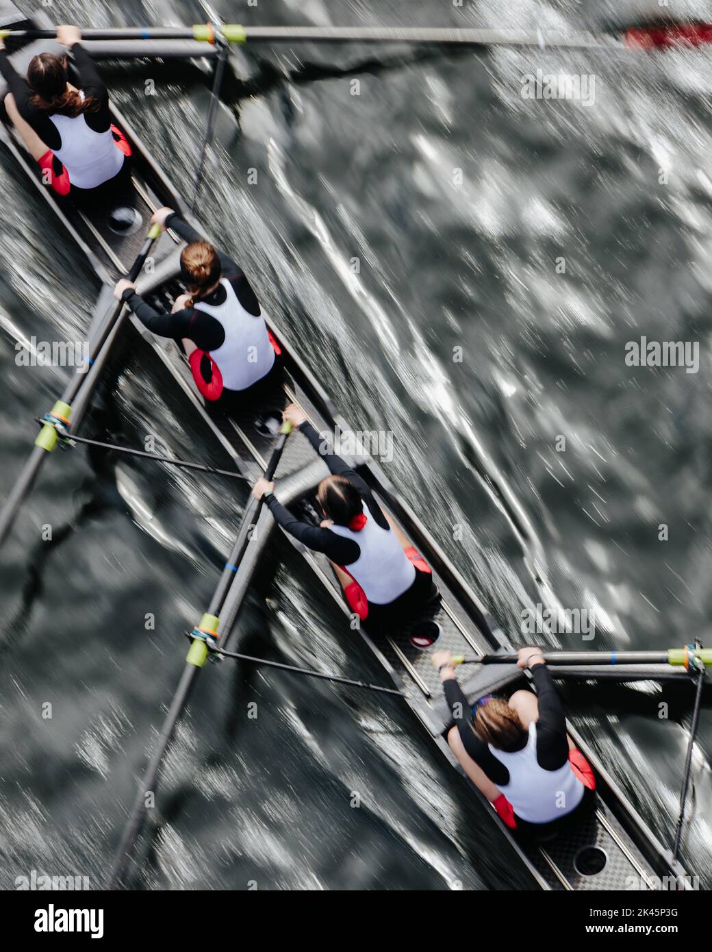 Overhead view of female crew racers rowing in an octuple racing shell ...