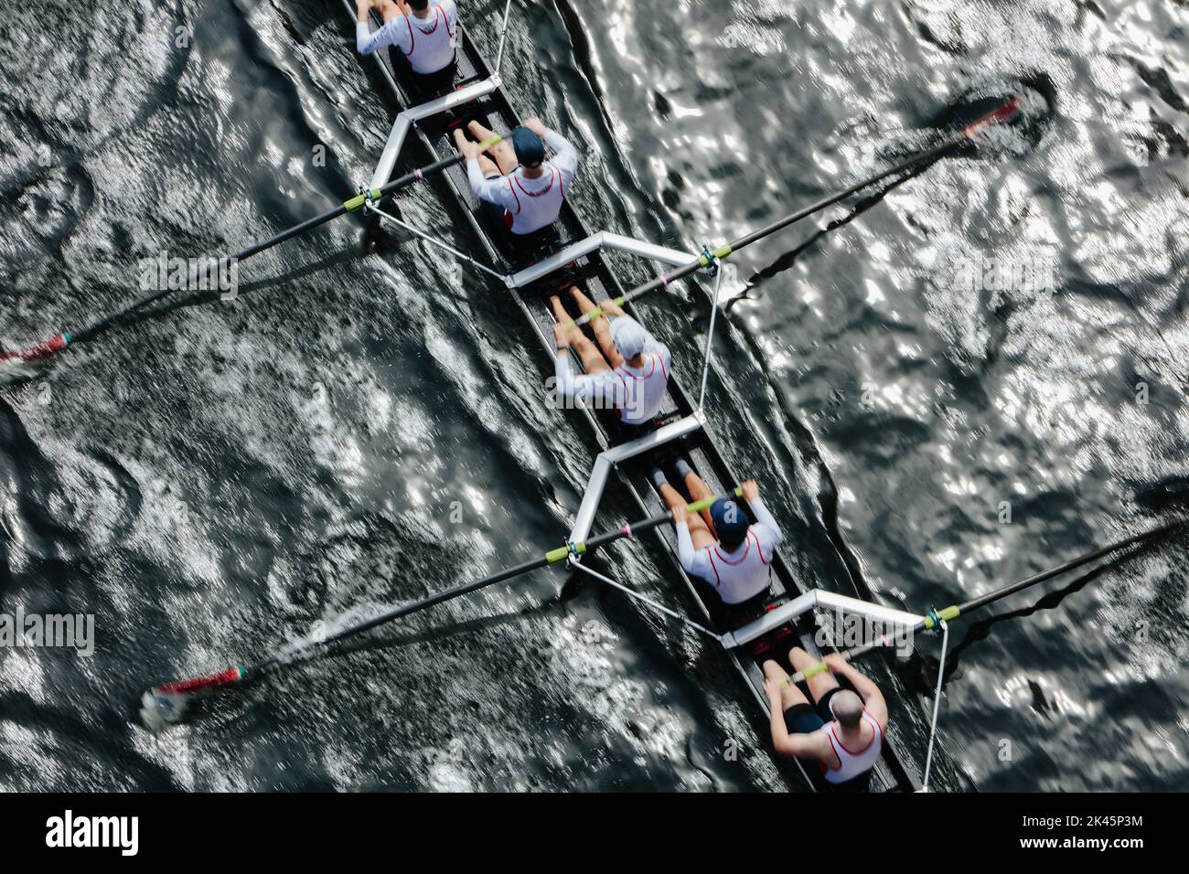 Overhead view of female crew racers rowing in an octuple racing shell ...