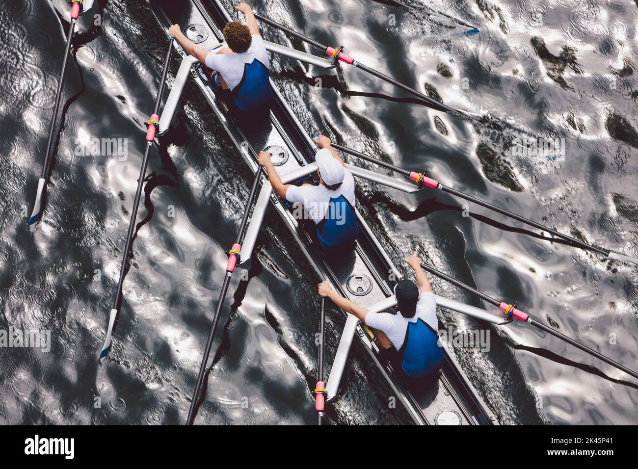 Overhead view of a crew rowing in an octuple racing shell boat, rowers ...