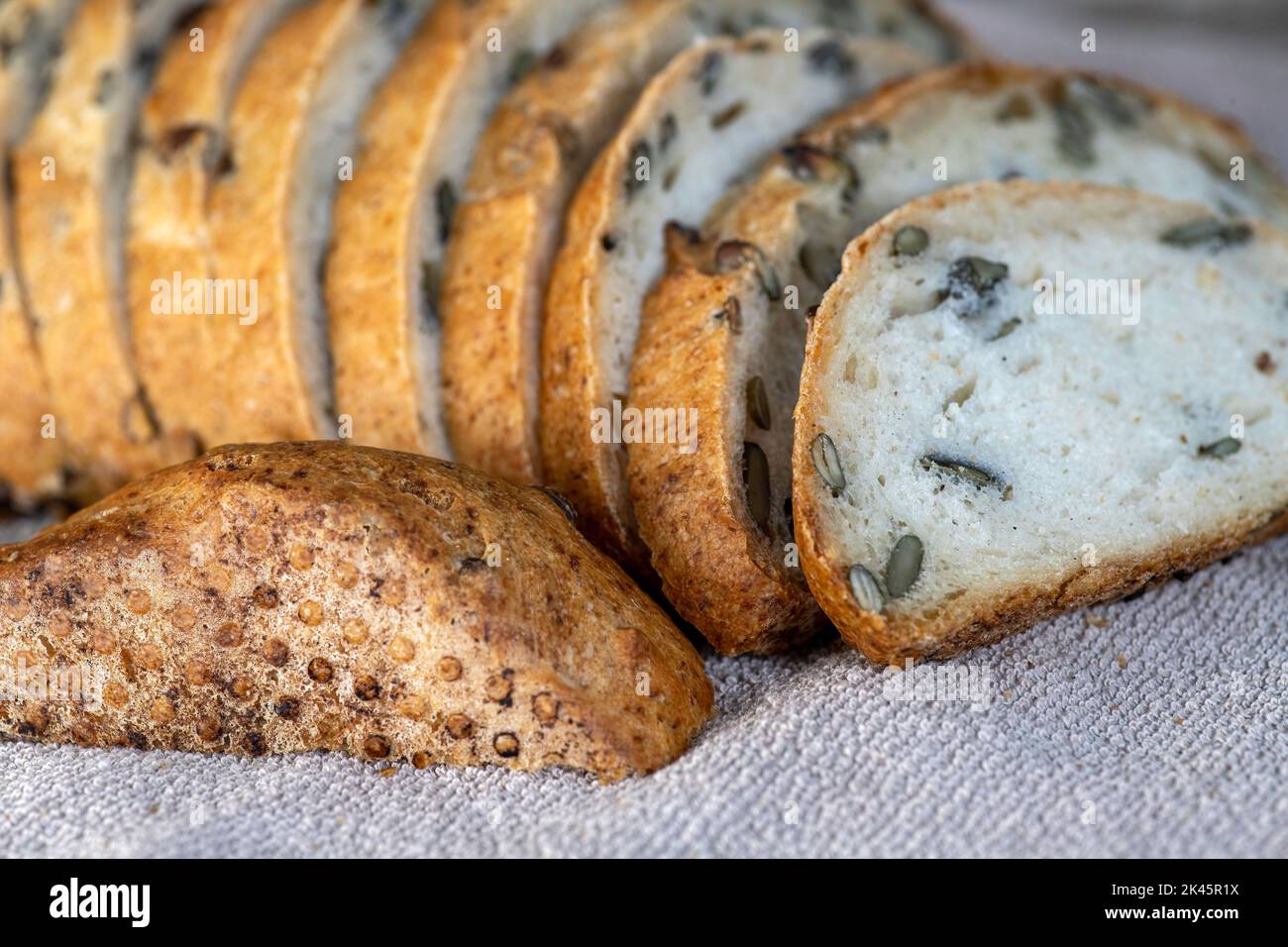 Sliced fresh wheat bread with pumpkin seeds close up Stock Photo - Alamy