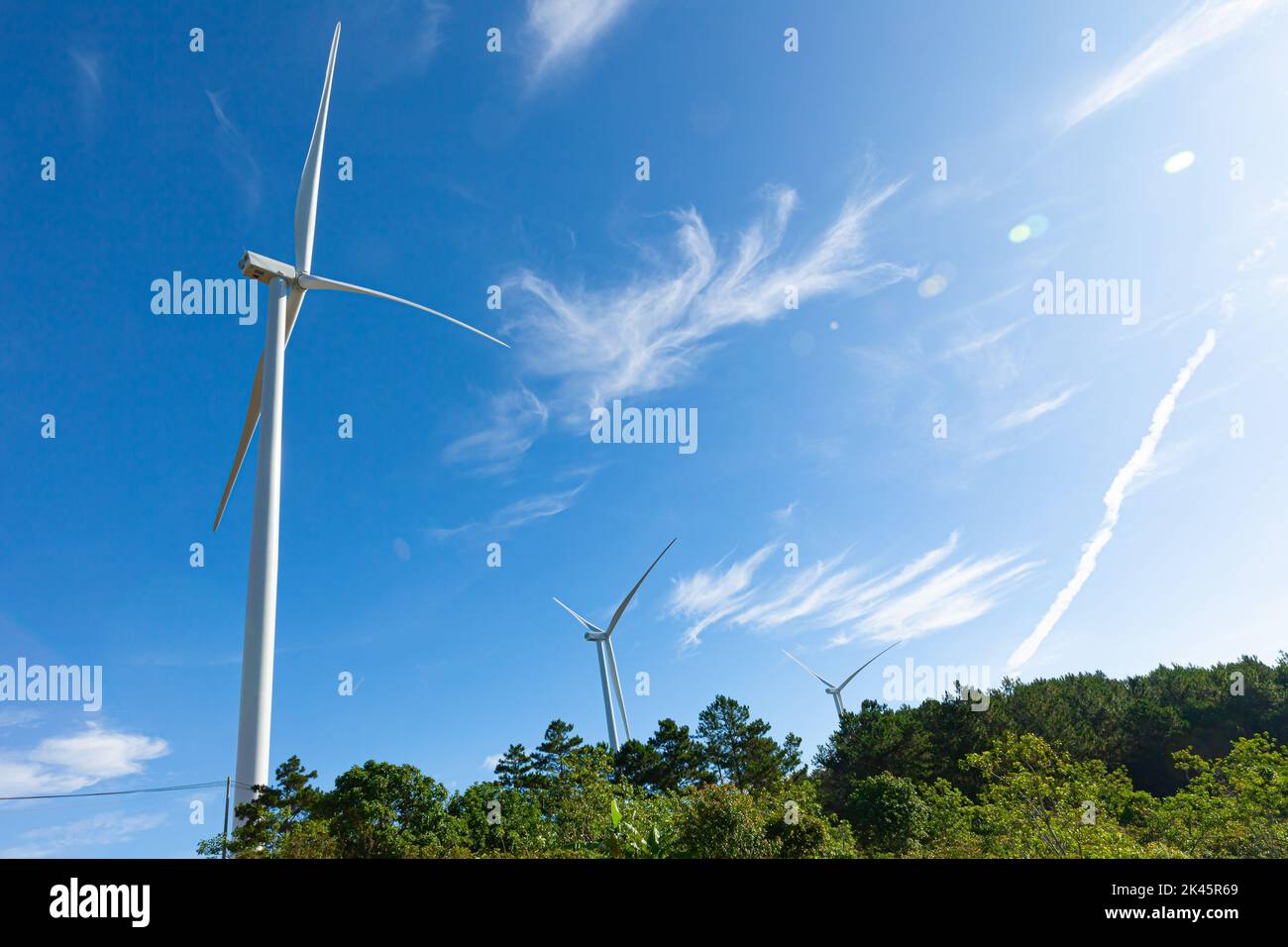 Renewable energy wind turbines windmill isolated on the beautiful blue ...
