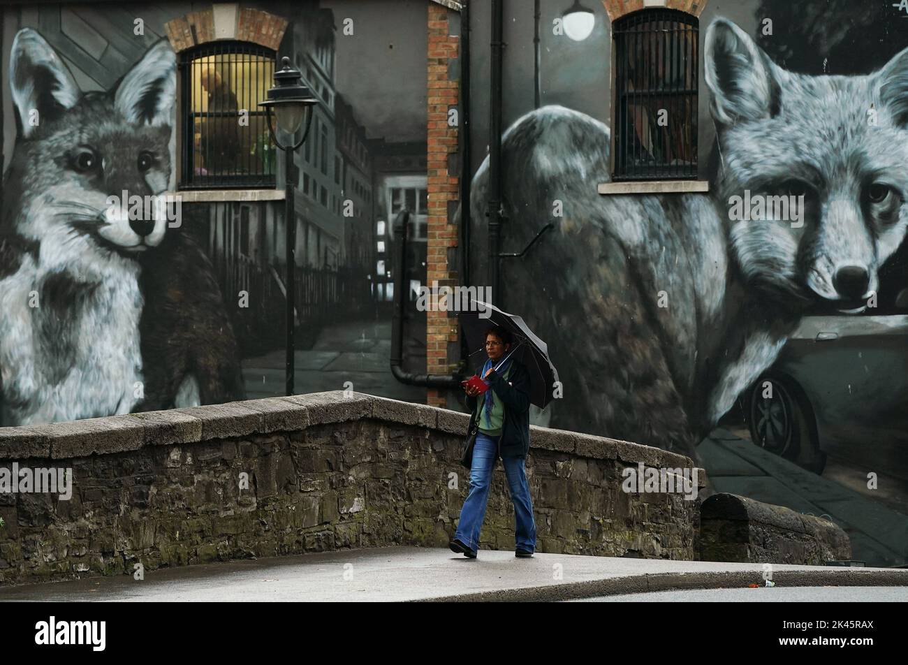 A man walks on Binn Bridge, Drumcondra, on a wet and windy day in ...