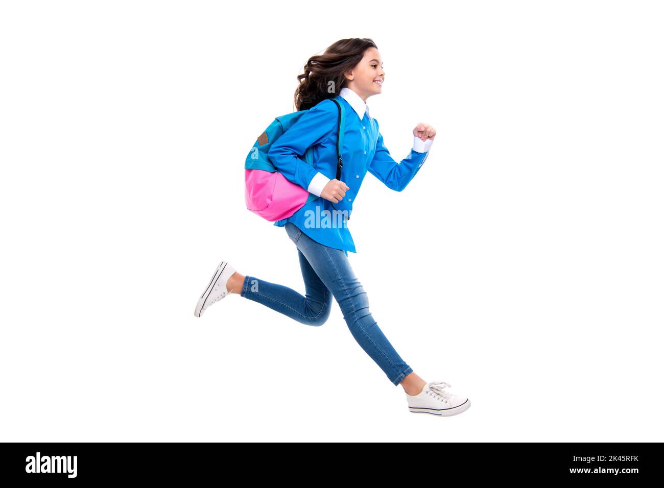 School girl in school uniform with school bag. Run and jump ...