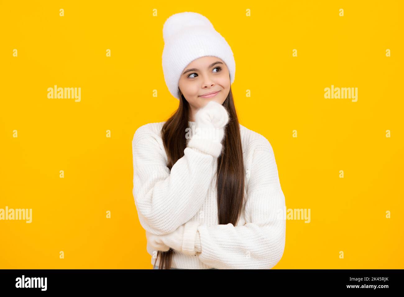 Beautiful teenager child over isolated yellow background with hand on ...
