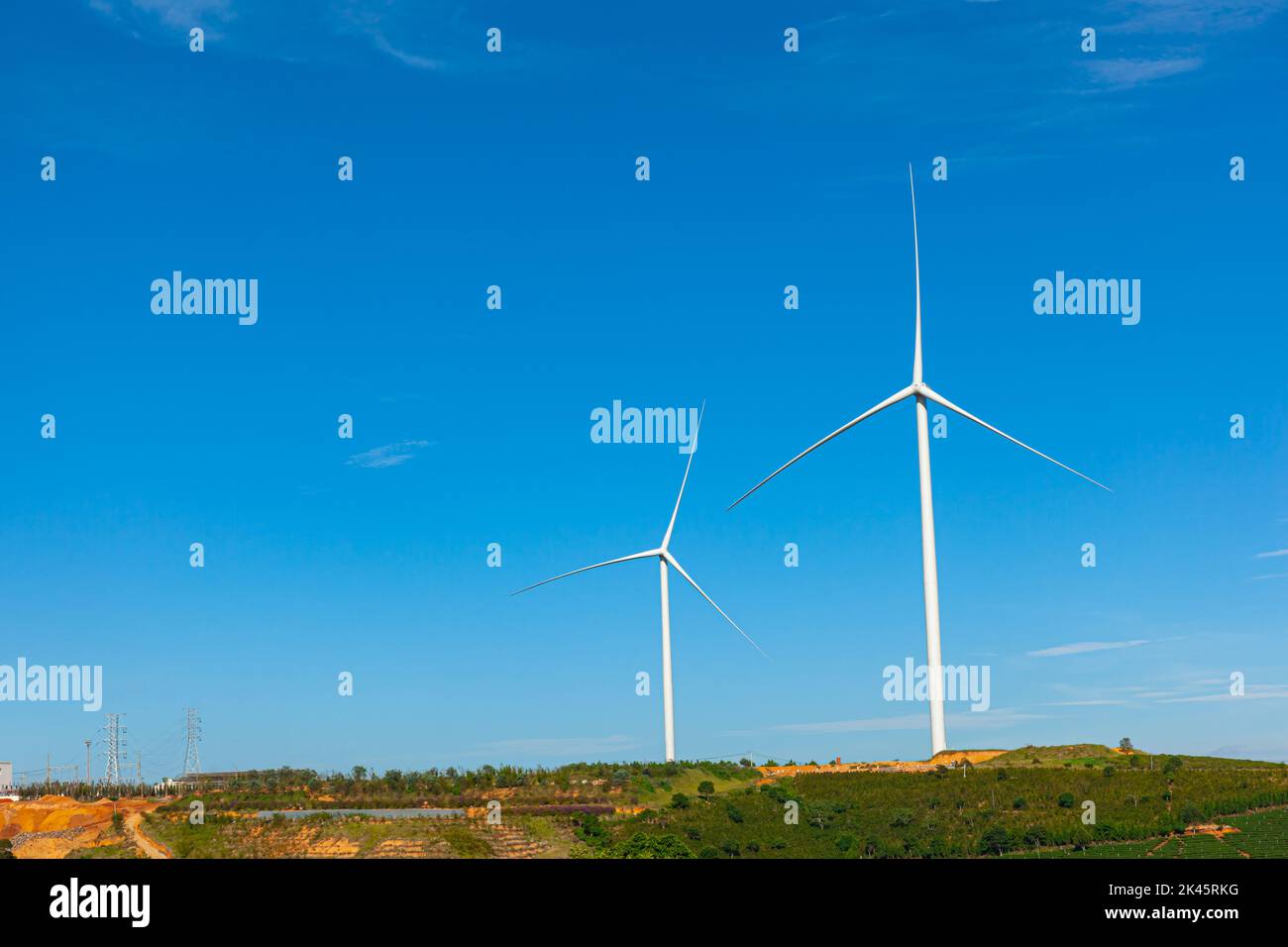 Renewable energy wind turbines windmill isolated on the beautiful blue ...