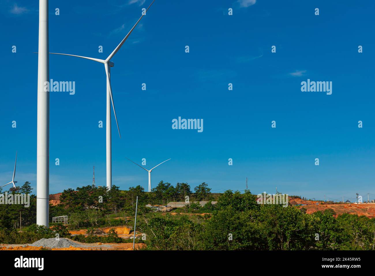 Renewable energy wind turbines windmill isolated on the beautiful blue ...