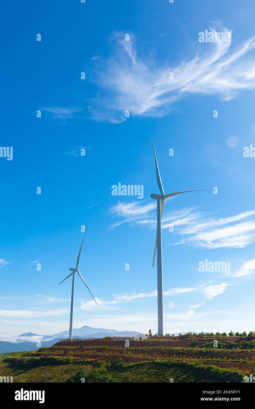 Renewable energy wind turbines windmill isolated on the beautiful blue ...