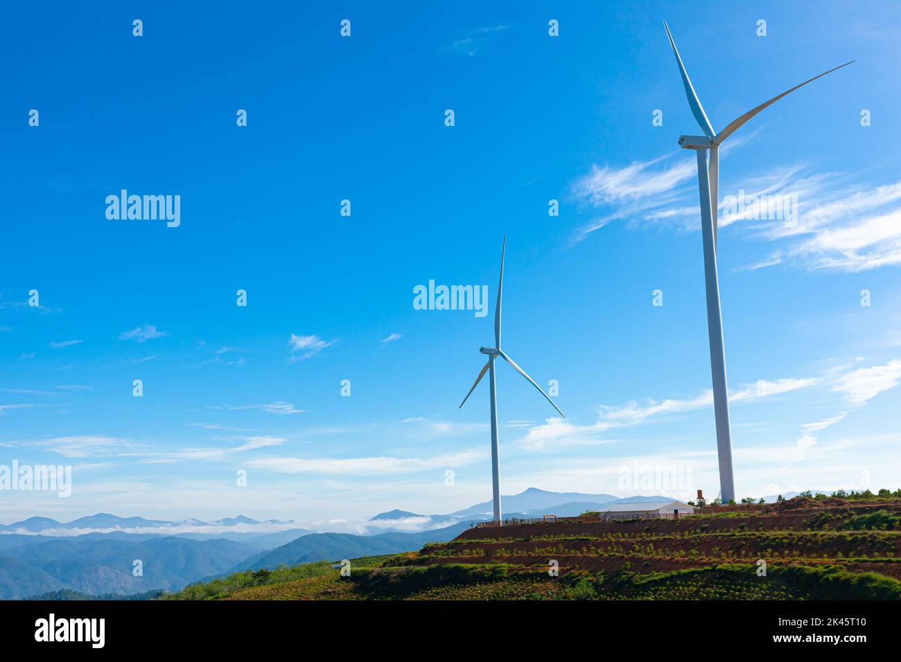 Renewable energy wind turbines windmill isolated on the beautiful blue ...