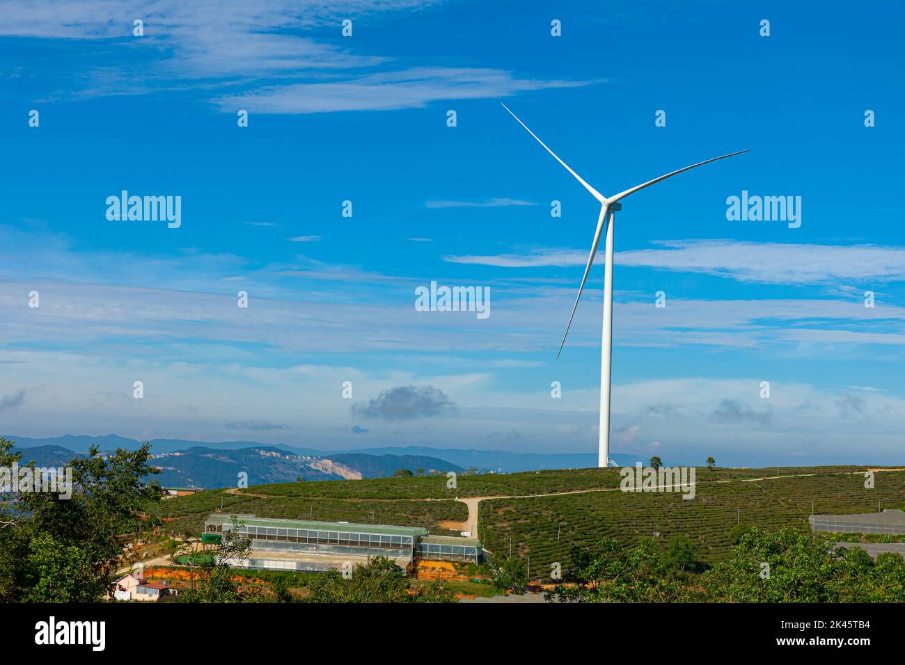 Renewable energy wind turbines windmill isolated on the beautiful blue ...