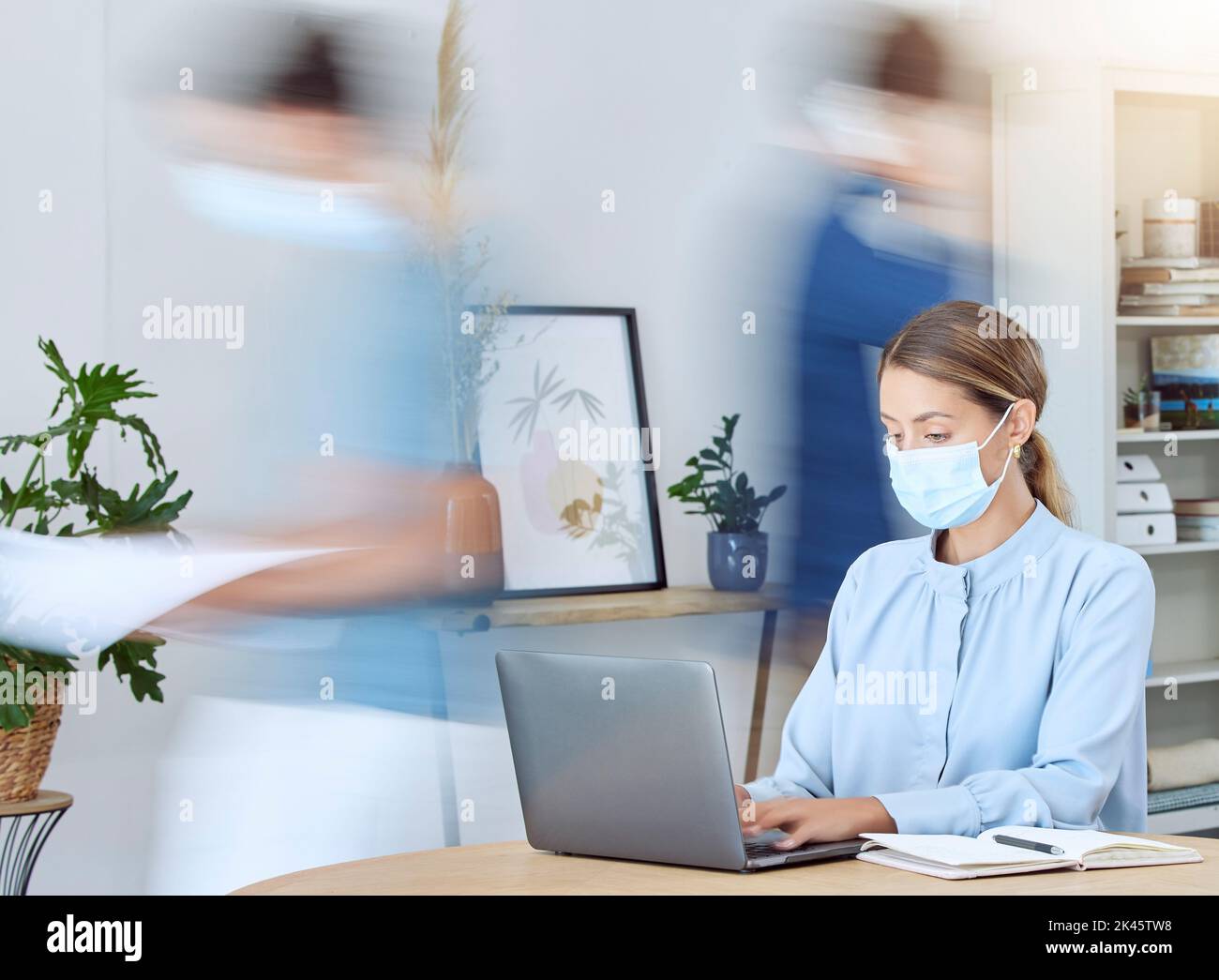 Covid, laptop and planning or busy woman in office with mask for ...