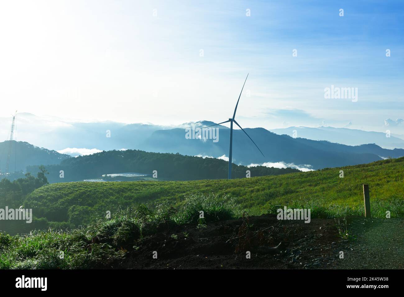 Renewable energy wind turbines windmill covered in fog in the early morning in Da Lat city, Lam ...