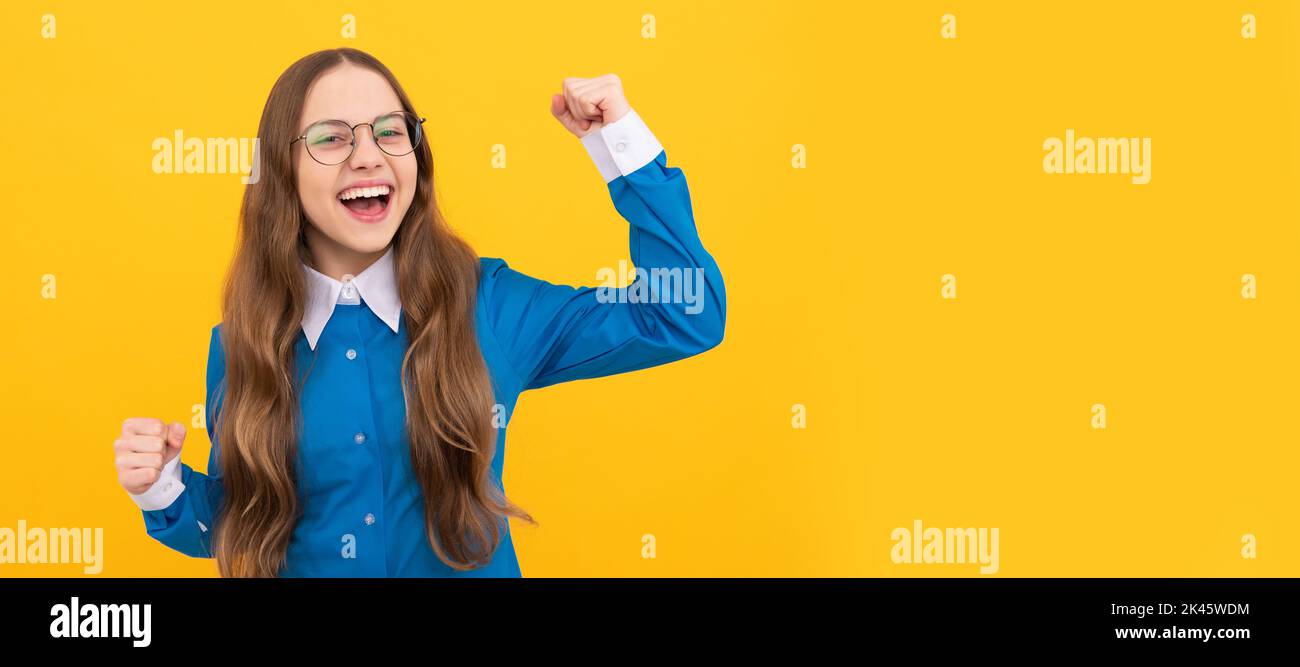 Education is the key to success. Happy tween girl show winning gesture ...