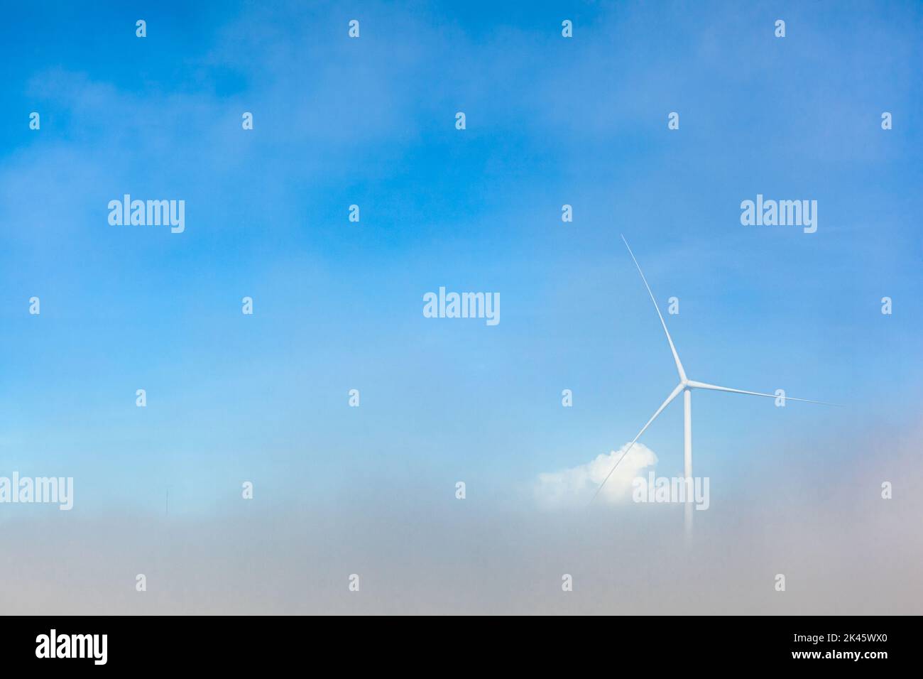 Renewable energy wind turbines windmill isolated on the beautiful blue ...