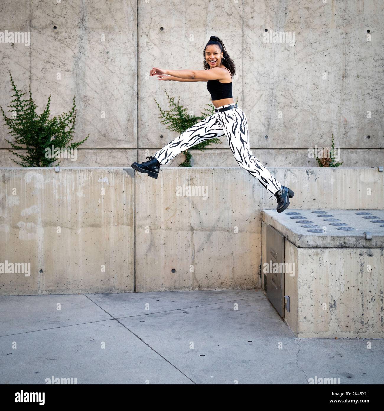 Sequence of Shots of Happy Young Black Woman Jumping Off a Walkway ...