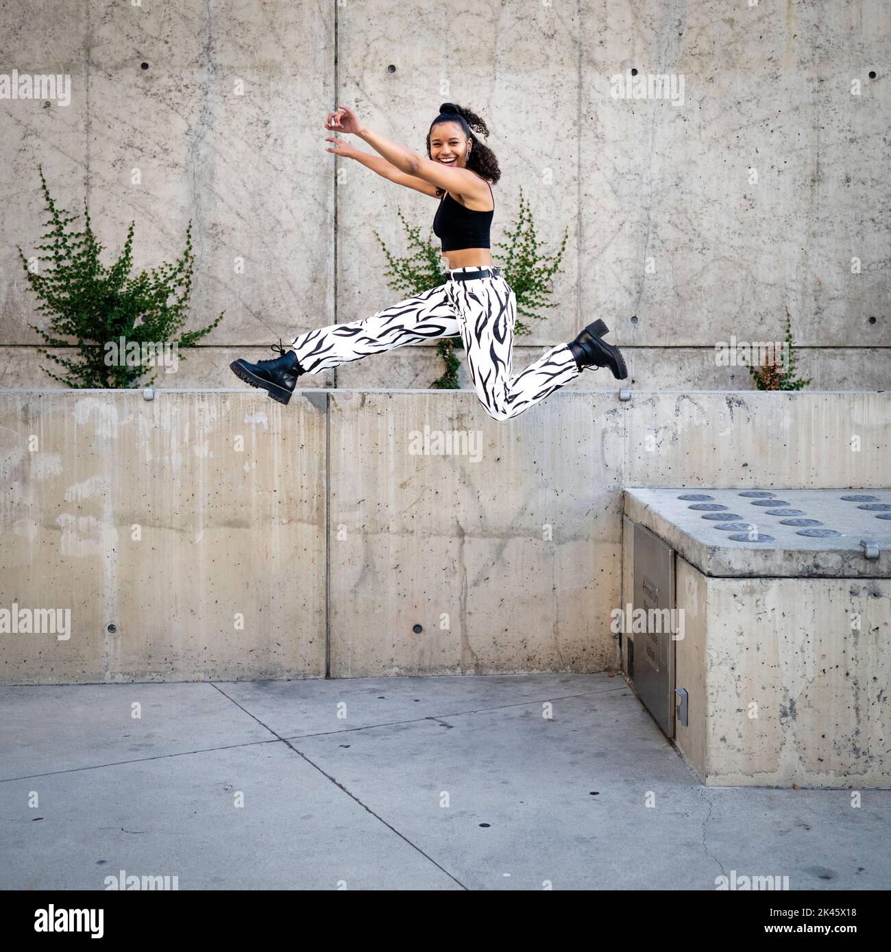 Sequence of Shots of Happy Young Black Woman Jumping Off a Walkway ...