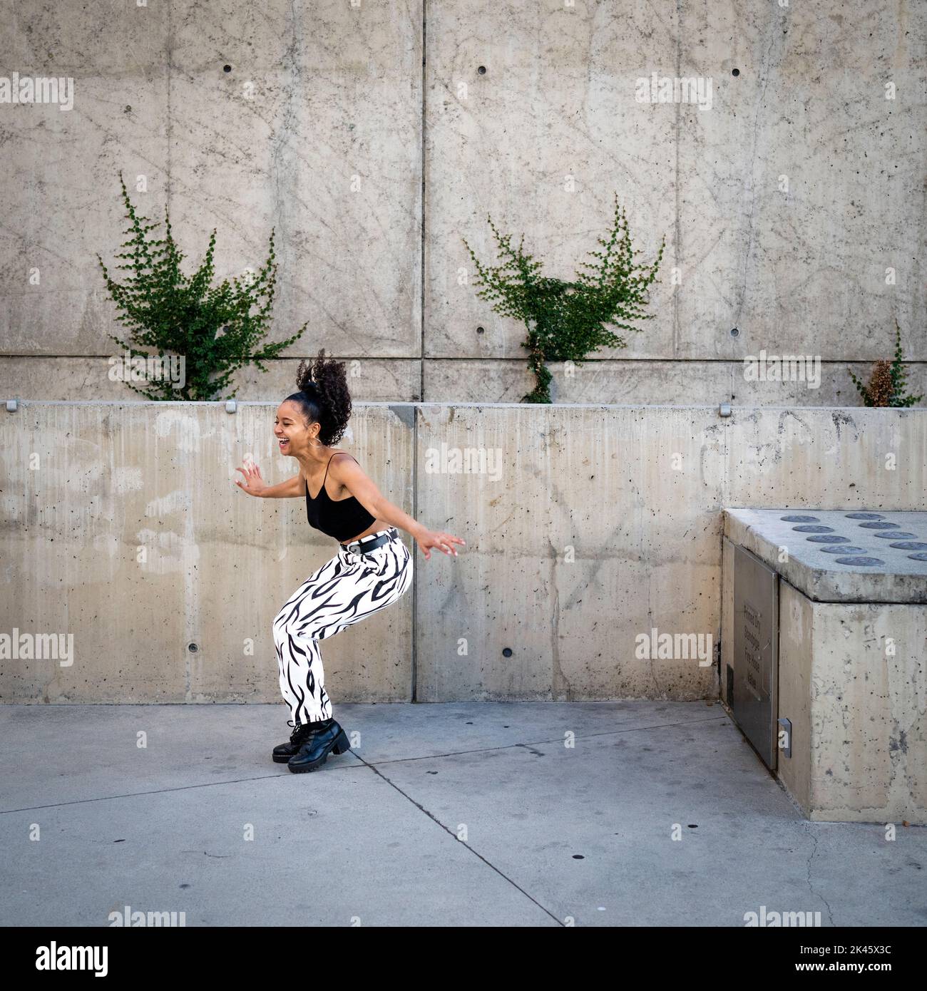 Sequence of Shots of Happy Young Black Woman Jumping Off a Walkway ...
