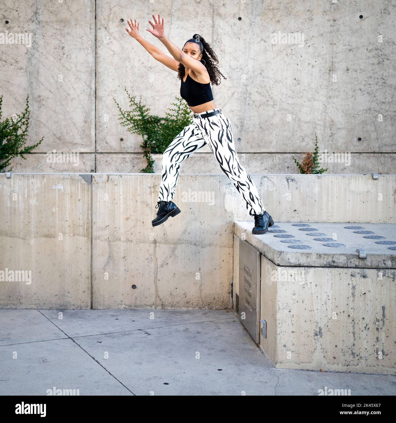 Sequence of Shots of Happy Young Black Woman Jumping Off a Walkway ...