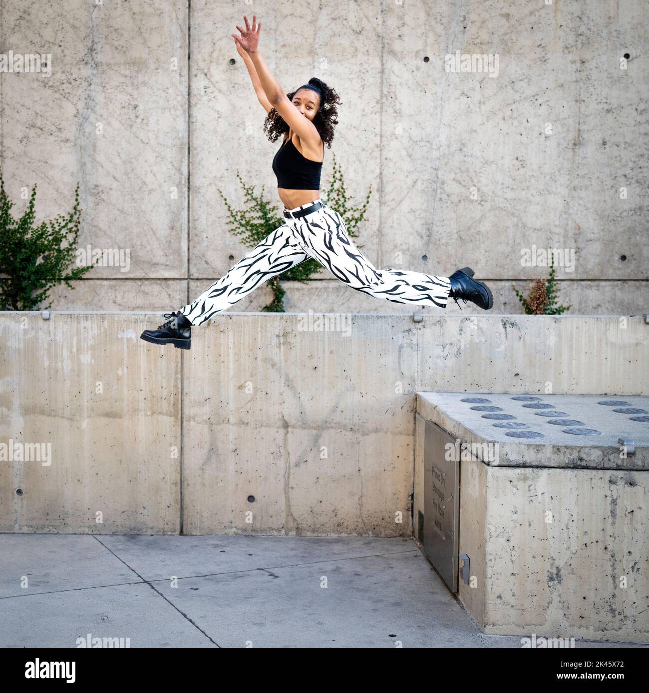 Sequence of Shots of Happy Young Black Woman Jumping Off a Walkway ...