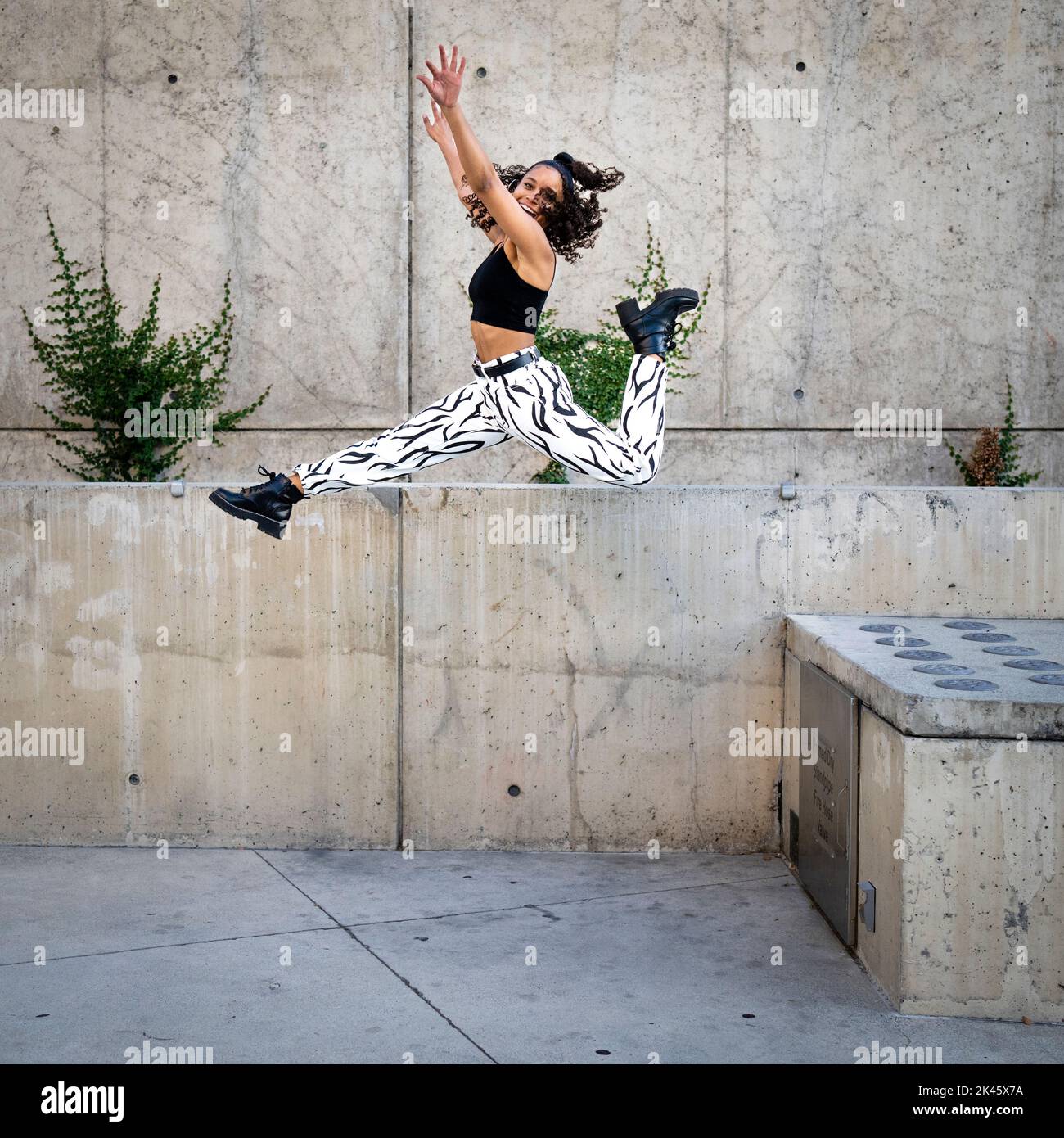 Sequence of Shots of Happy Young Black Woman Jumping Off a Walkway ...