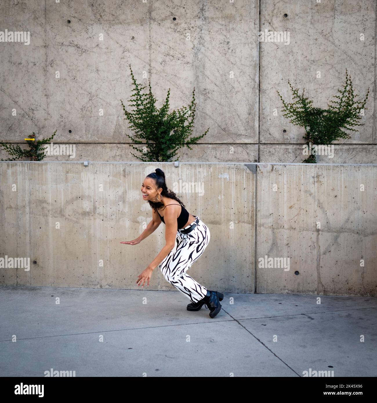 Sequence of Shots of Happy Young Black Woman Jumping Off a Walkway ...