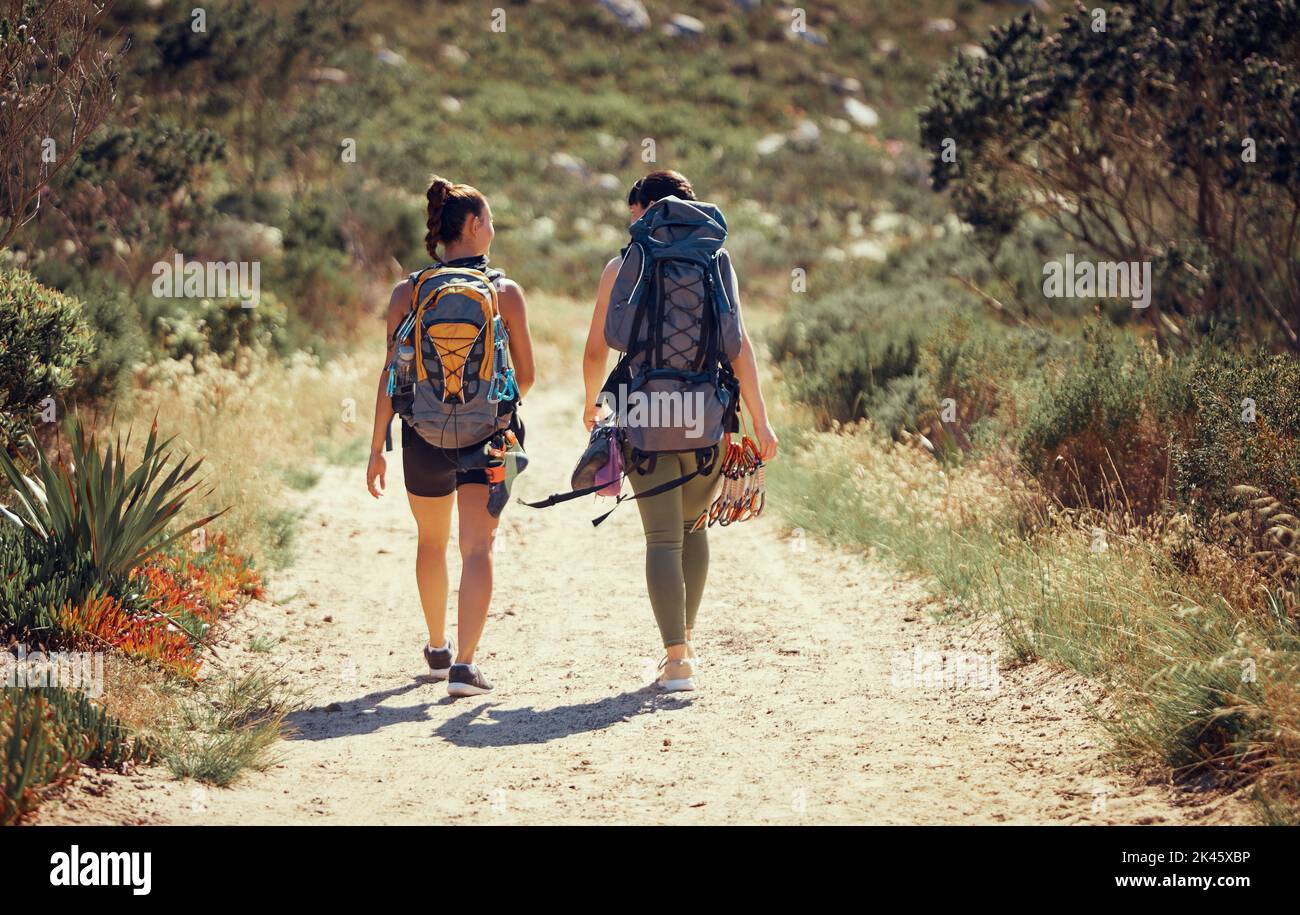 Fitness and workout friends hiking or walking in nature on a mountain ...