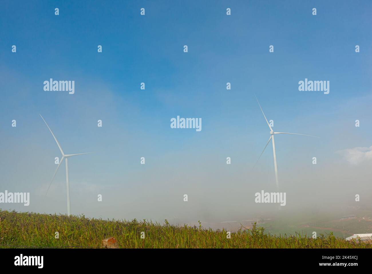 Renewable energy wind turbines windmill isolated on the beautiful blue ...