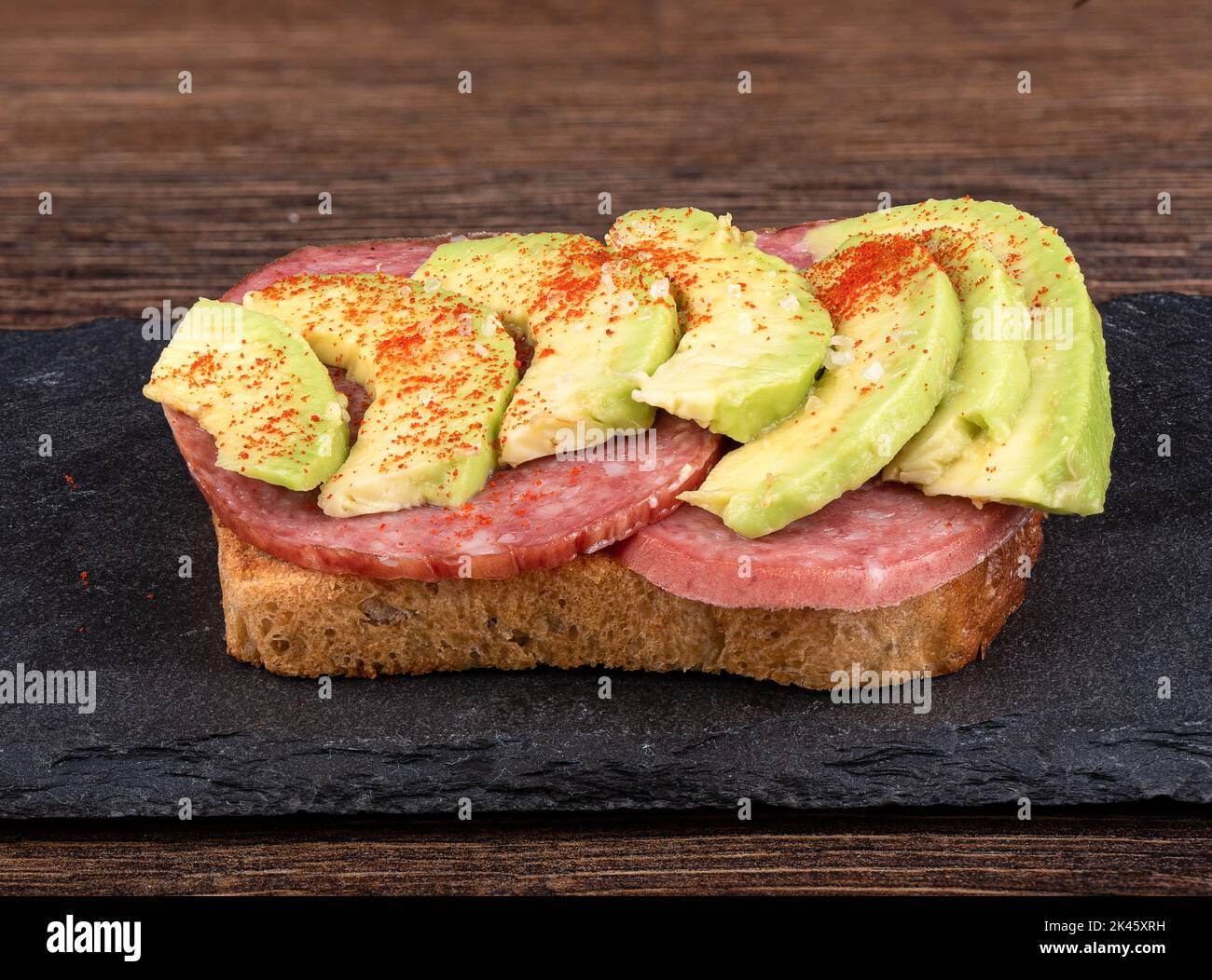 Toast with grain bread, half-smoked sausage and avocado slices ...