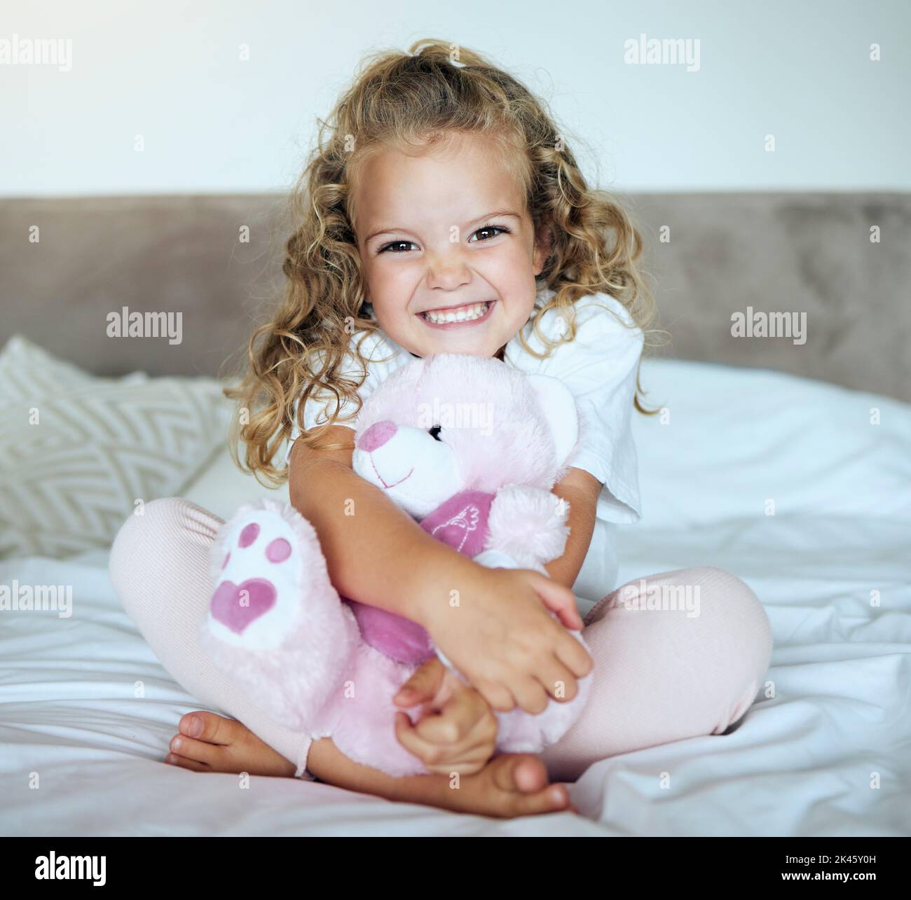 Children, teddy bear and girl child hug her stuffed animal with a smile ...