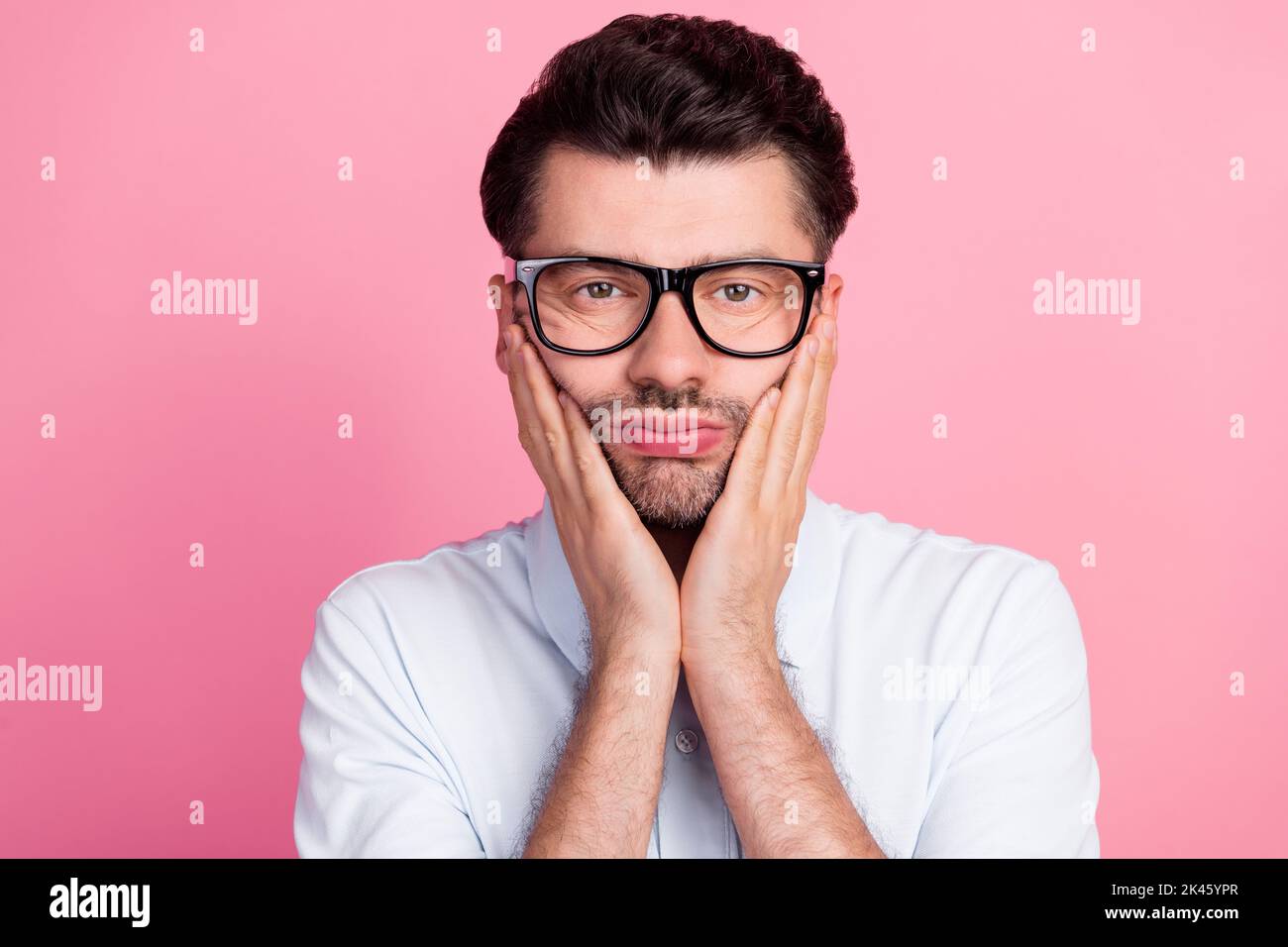 Closeup photo of young attractive handsome touch cheeks palms unhappy ...