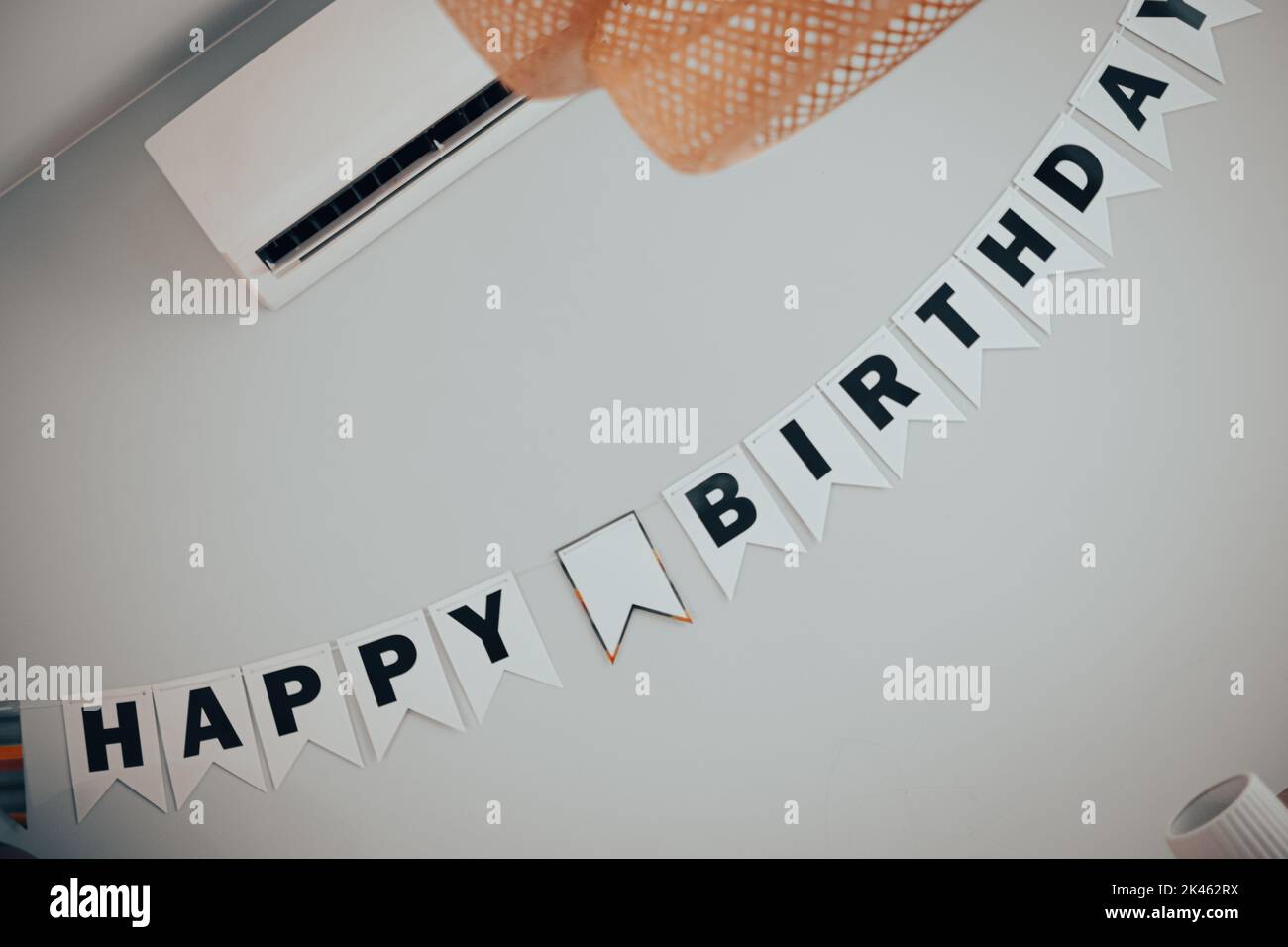 Happy Birthday ribbon detail with a big decoration balloon on a grey ...
