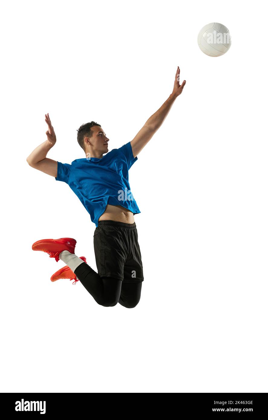 Studio shot of young man, volleyball player playing volleyball isolated ...