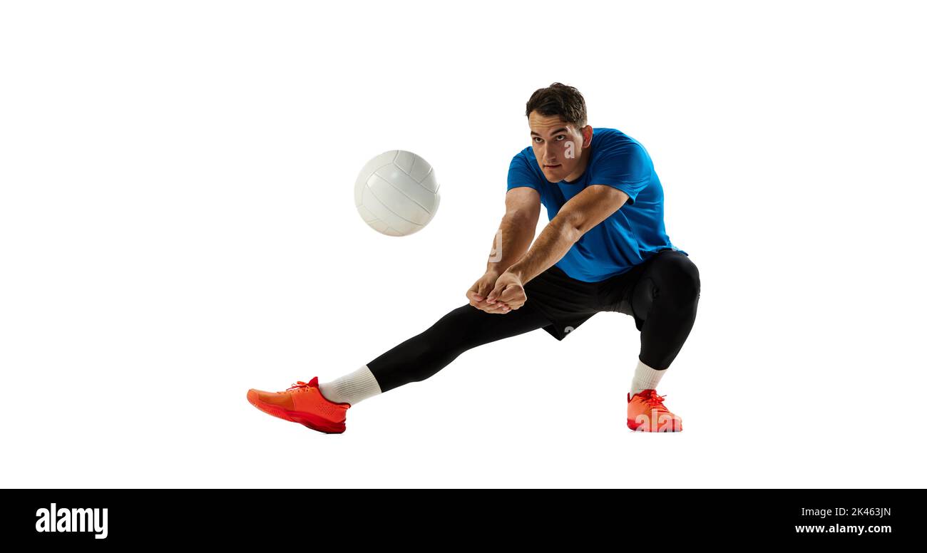 Dynamic portrait of male volleyball player training with ball isolated ...