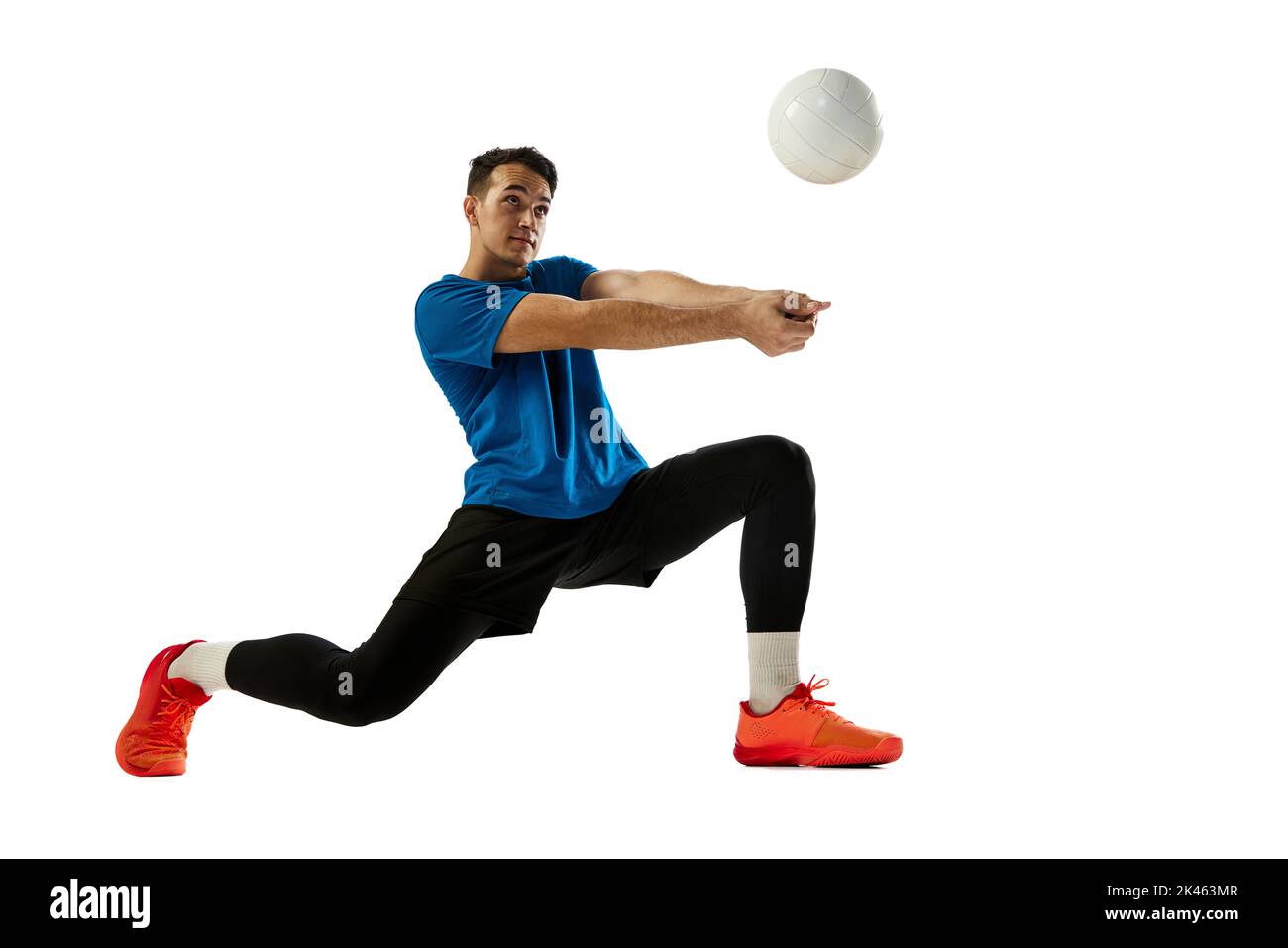 Dynamic portrait of male volleyball player training with ball isolated ...